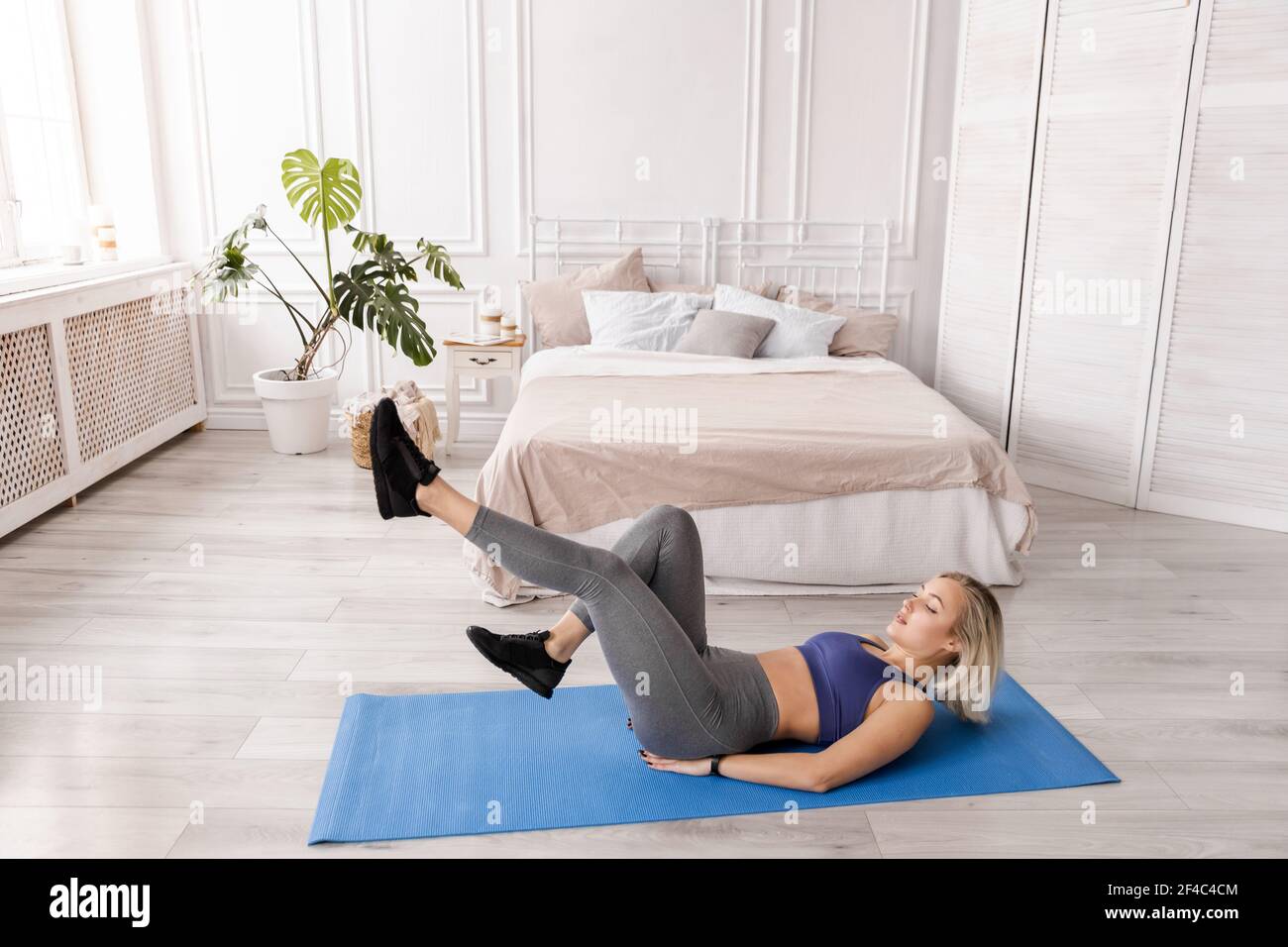 Athletic young girl exercising, doing criss-cross exercises, bicycle ...