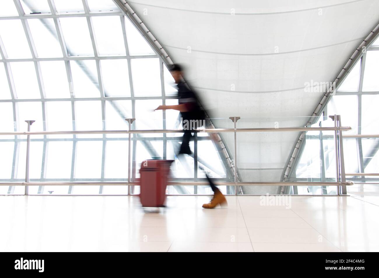 An unidentifiable person walking in motion blur on white corridor with ...