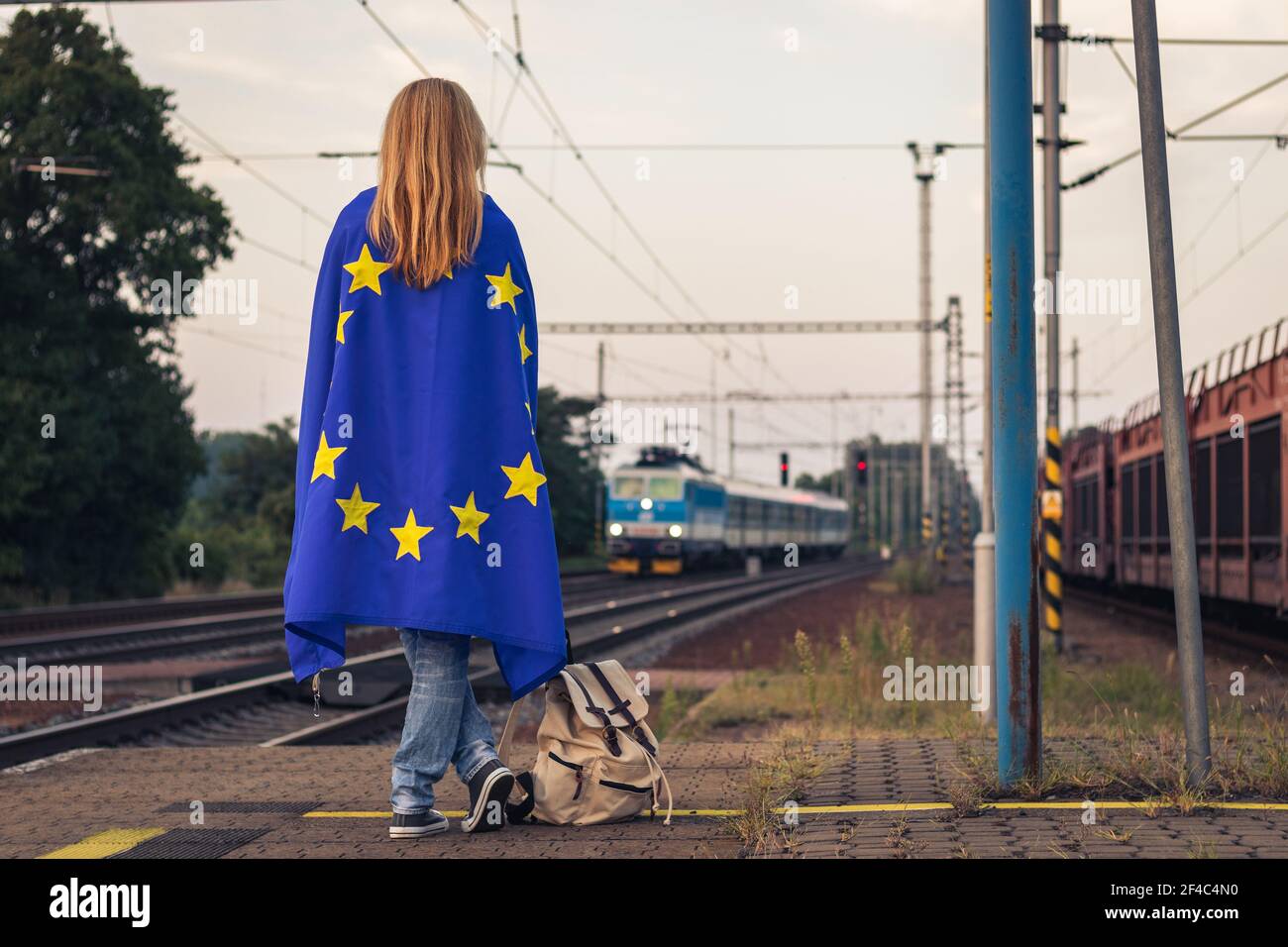 Traveling through the European Union by train. Woman with EU flag at ...