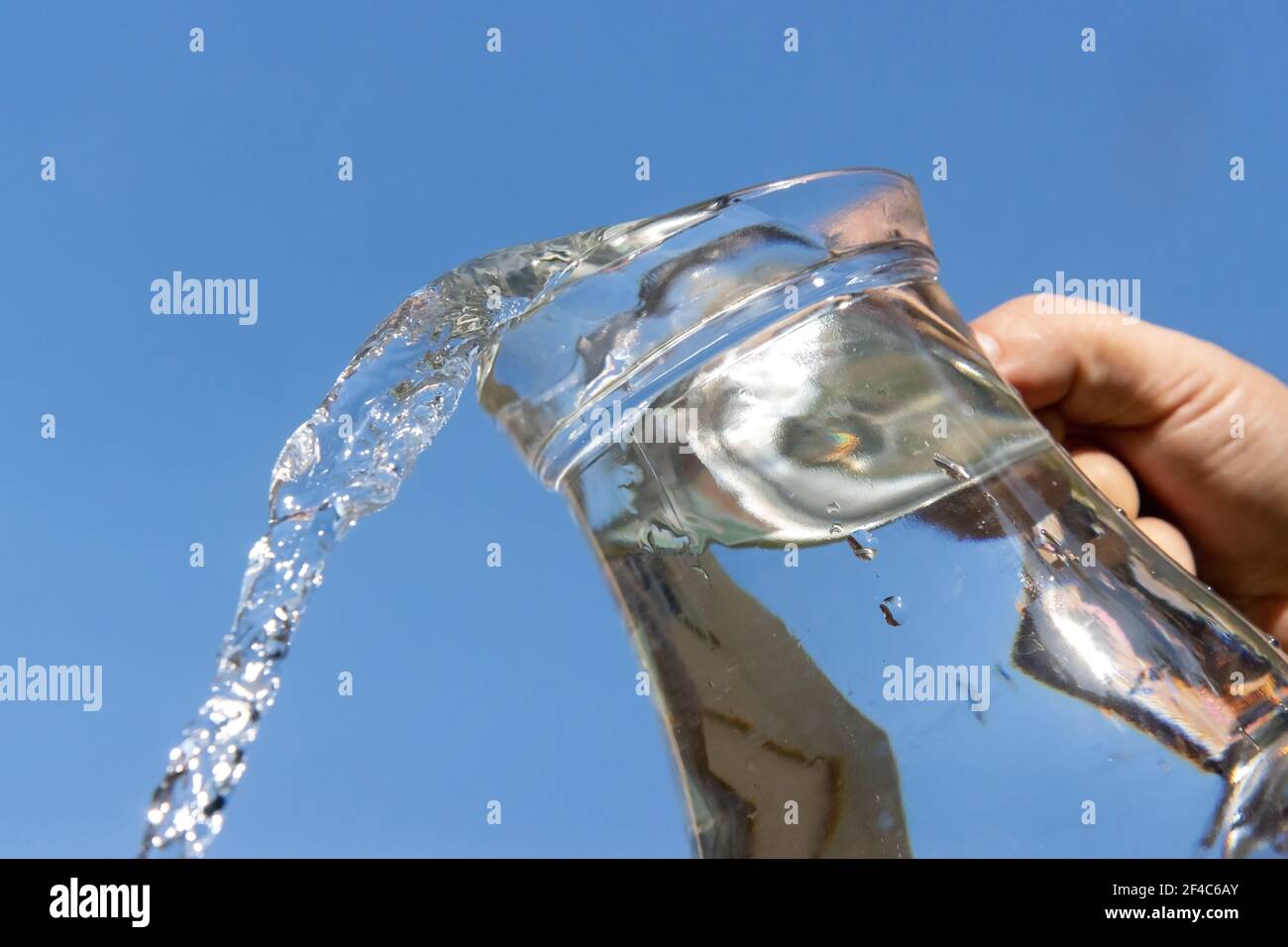 Hand pouring water from bottle hi-res stock photography and images - Alamy