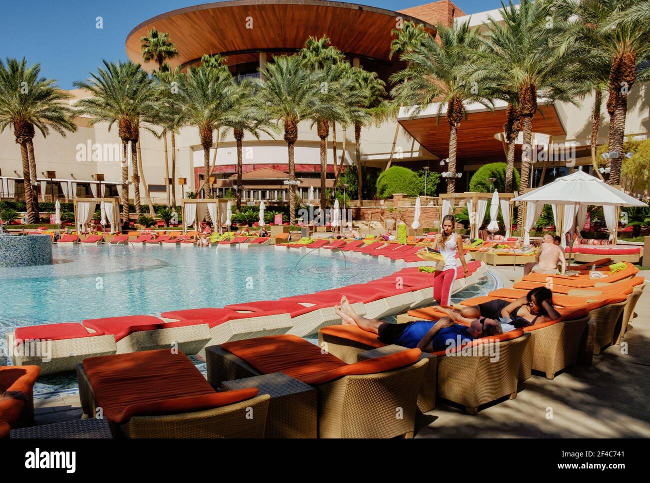 Guests relax by the swimming pool at the Red Rock Casino Resort and Spa ...