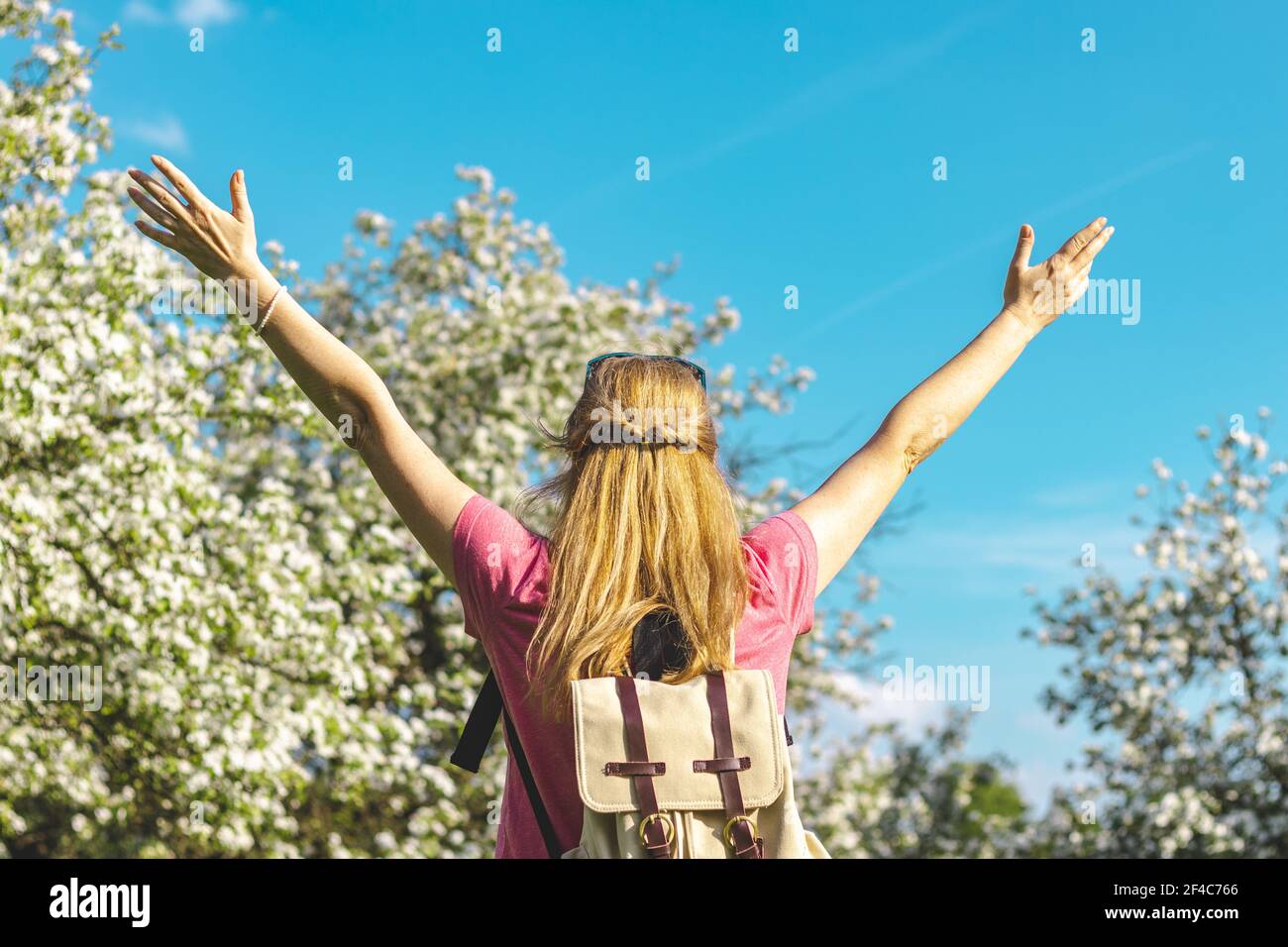 Welcome spring. Happy caucasian woman raising opened arms and she is ...