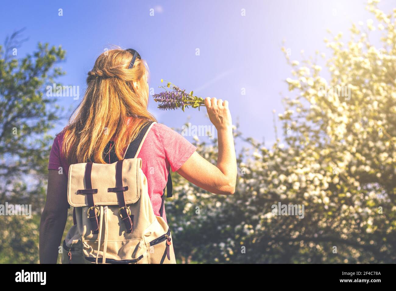 Welcome spring. Happy caucasian woman is enjoying spring in blooming ...