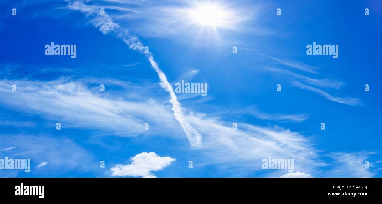 loud panorama with bright sun and blue sky Stock Photo - Alamy