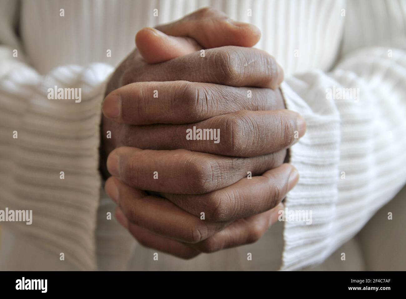 man praying to god with hands together stock photo Stock Photo - Alamy