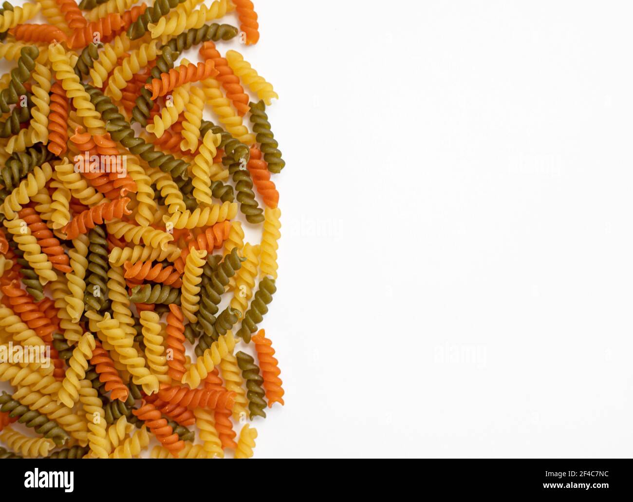 Tricolor, dry and raw pasta on a white background Stock Photo - Alamy