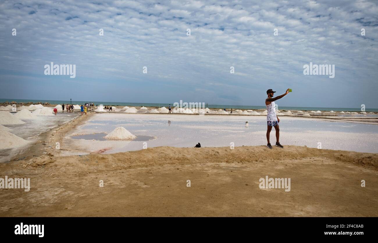 A tourist snaps a selfie at the Manaure Salt Flats in La Guajira ...
