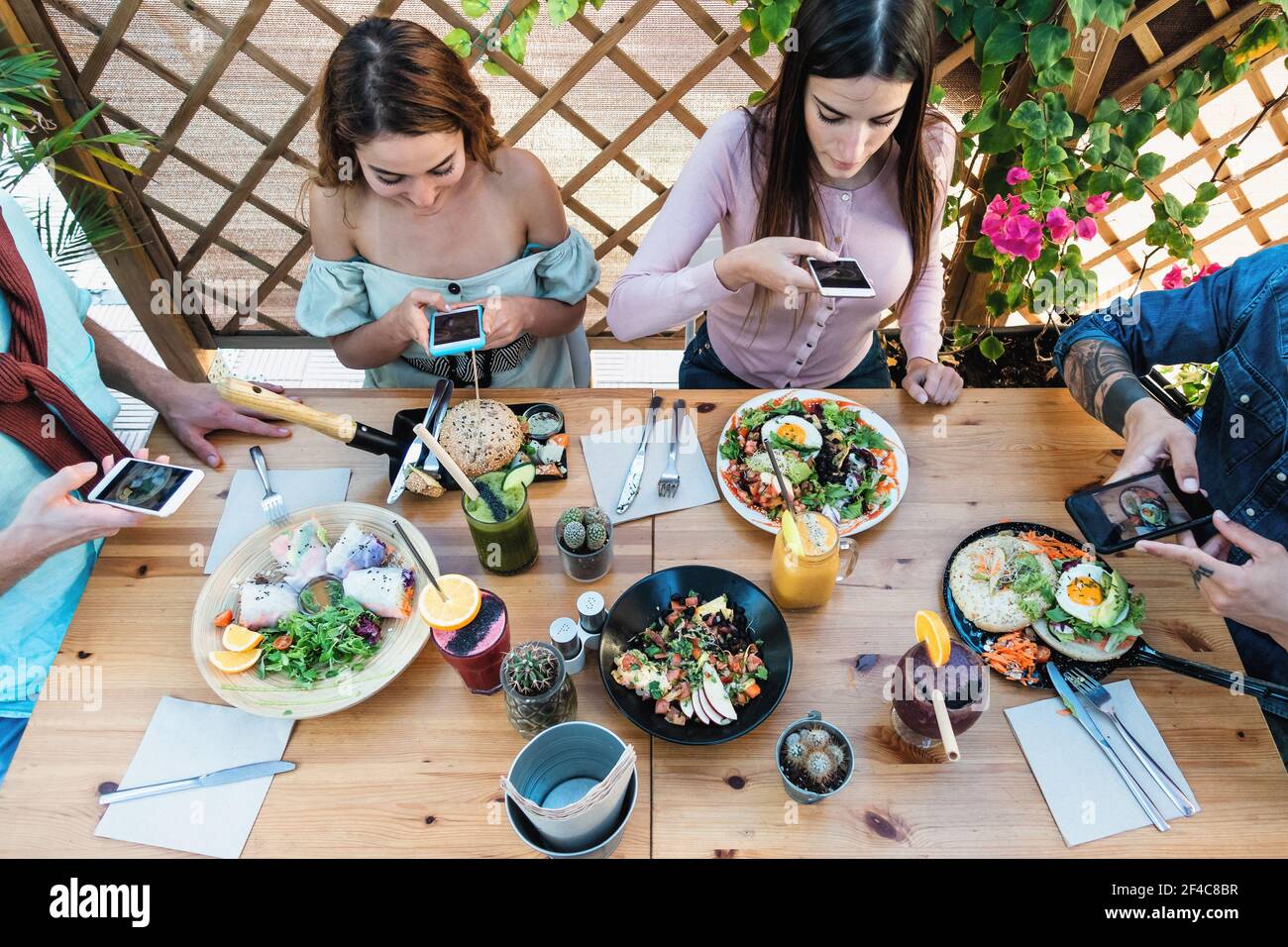 Young people taking food pictures with mobile smartphone to share on ...