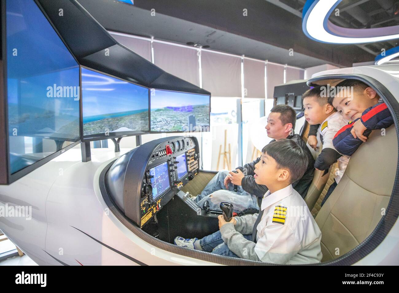 Chongqing, China. 20th Mar, 2021. Children experience dynamic flight ...