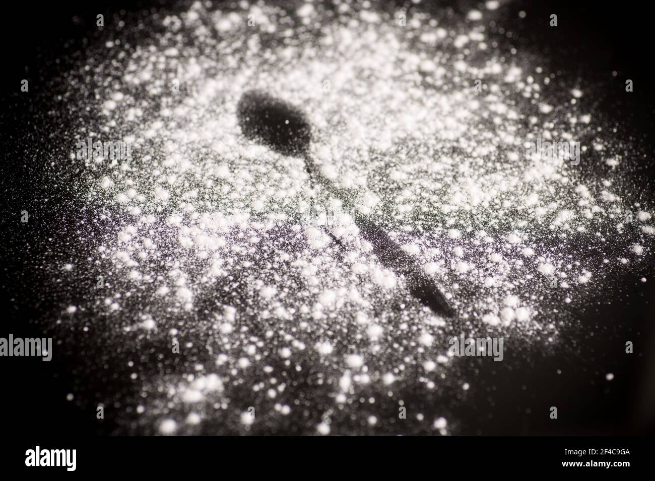 sweet white icing sugar and spoon trace on black background Stock Photo ...