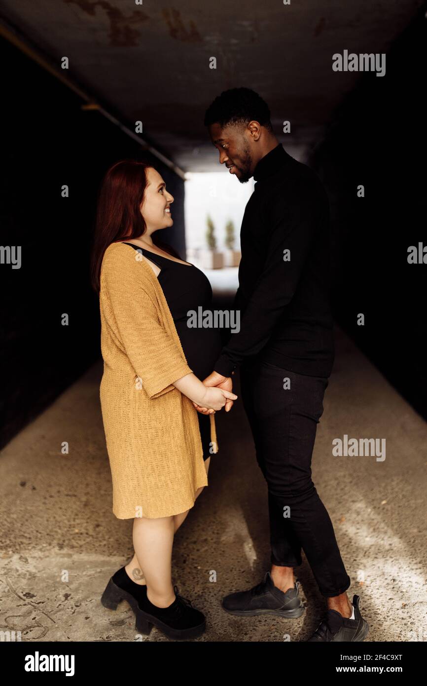 Fashion couple walking at the city, stylish woman cuddle with ...