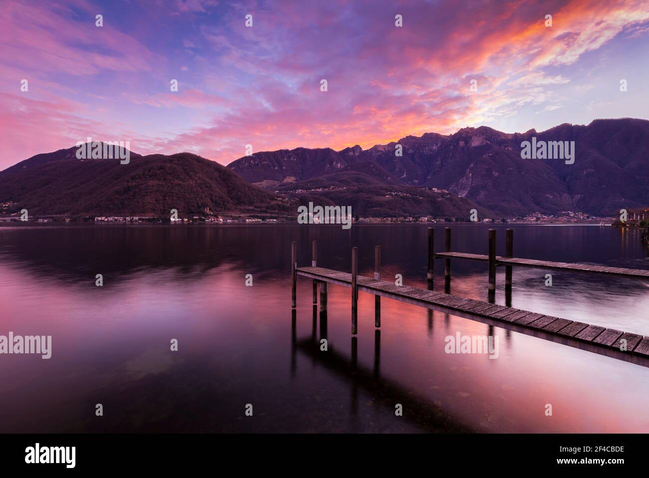 Sunrise explosion of colors in front of the Generoso Mount from a pier ...