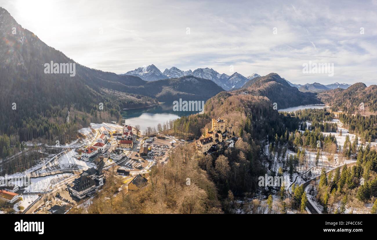 Aerial drone shot of Hohenschwangau by lake in Fussen with view of Alps ...