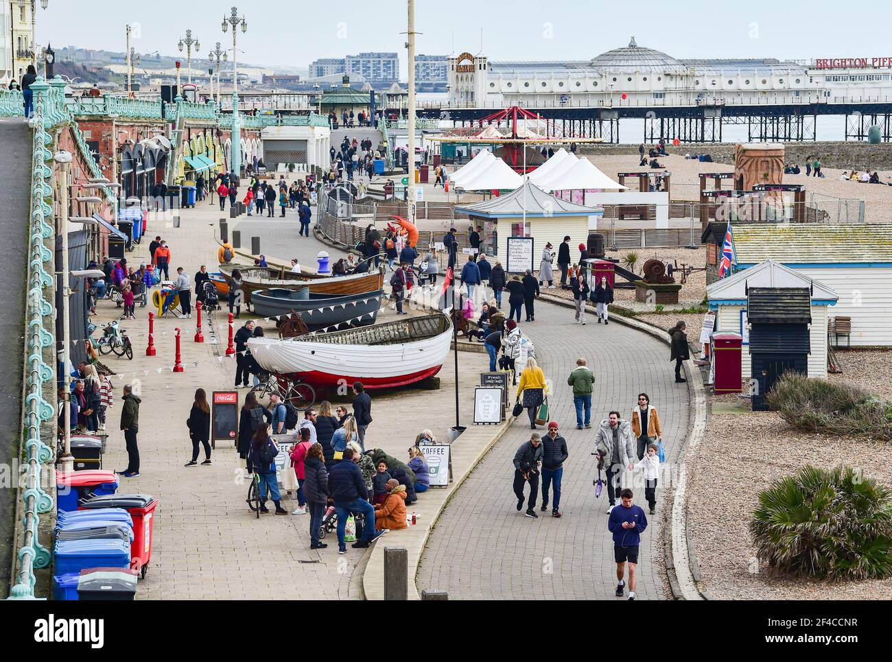 Brighton UK 20th March 2021 - Visitors enjoy a walk along Brighton ...