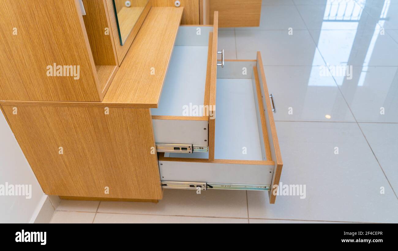 A wooden wardrobe with open drawers Stock Photo - Alamy