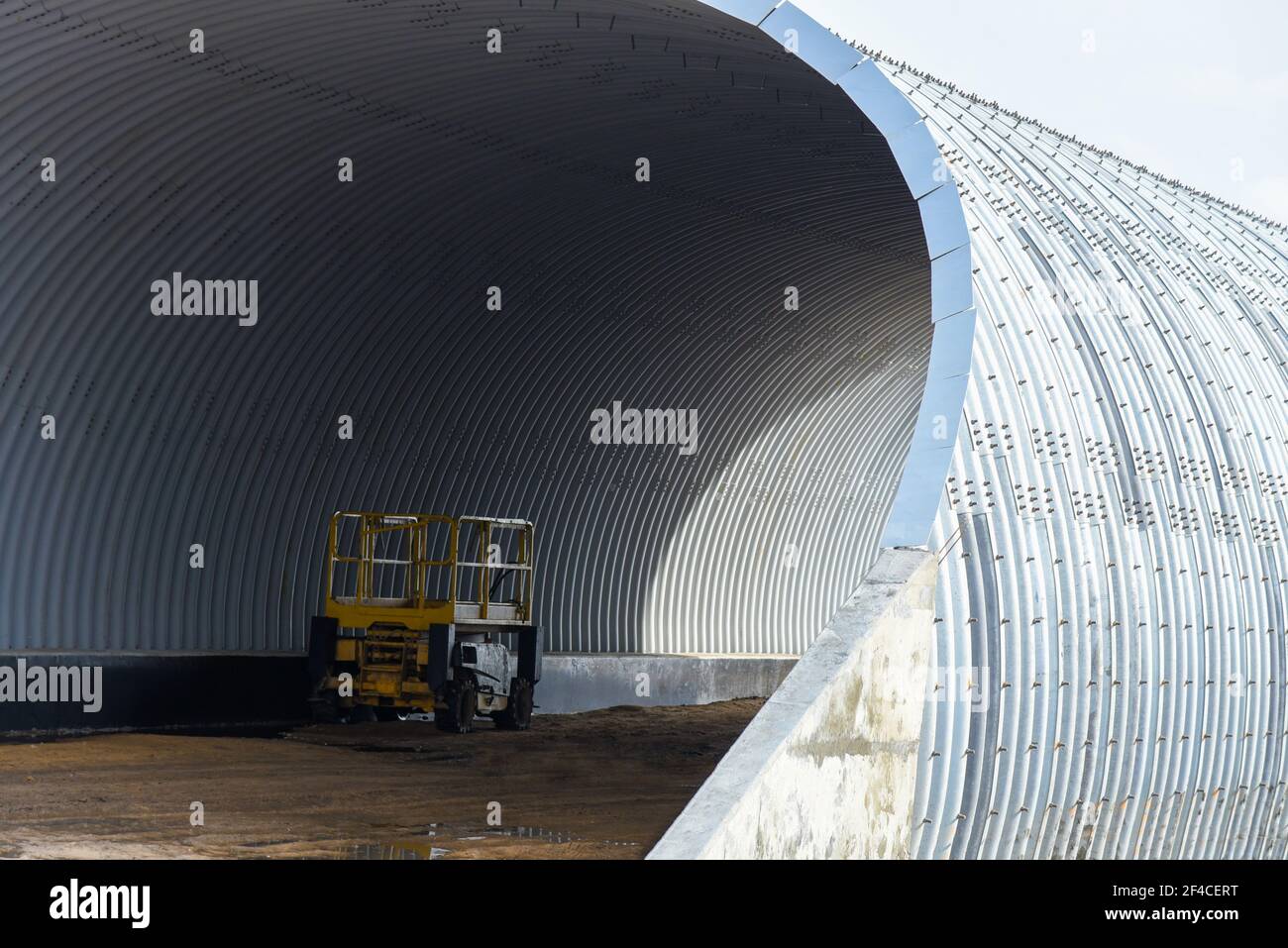 Construction of a metal tunnel under the road Stock Photo - Alamy