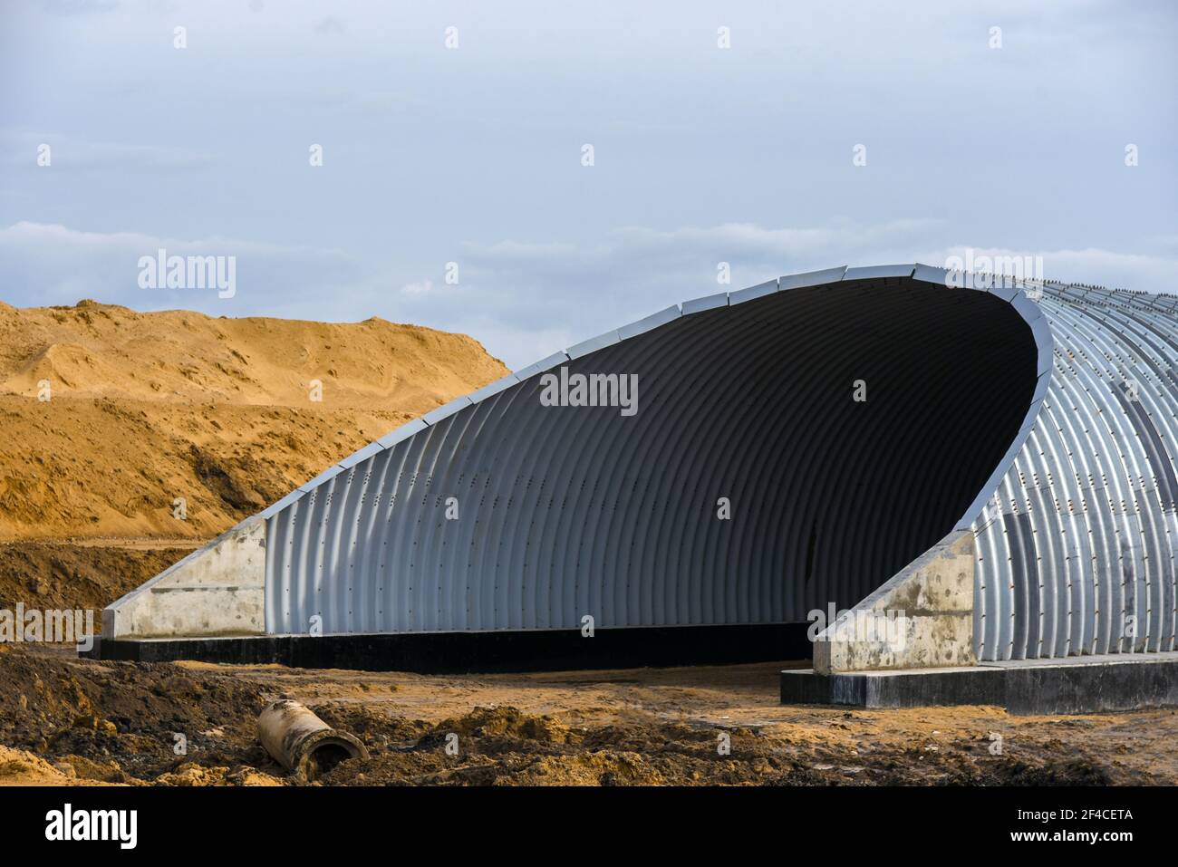 Construction of a metal tunnel under the road Stock Photo - Alamy