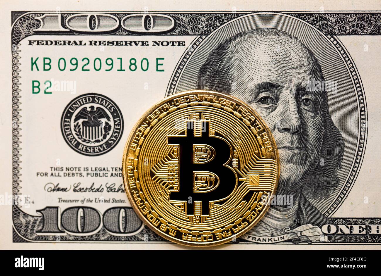 Bitcoin on 100 dollar banknote background Stock Photo - Alamy