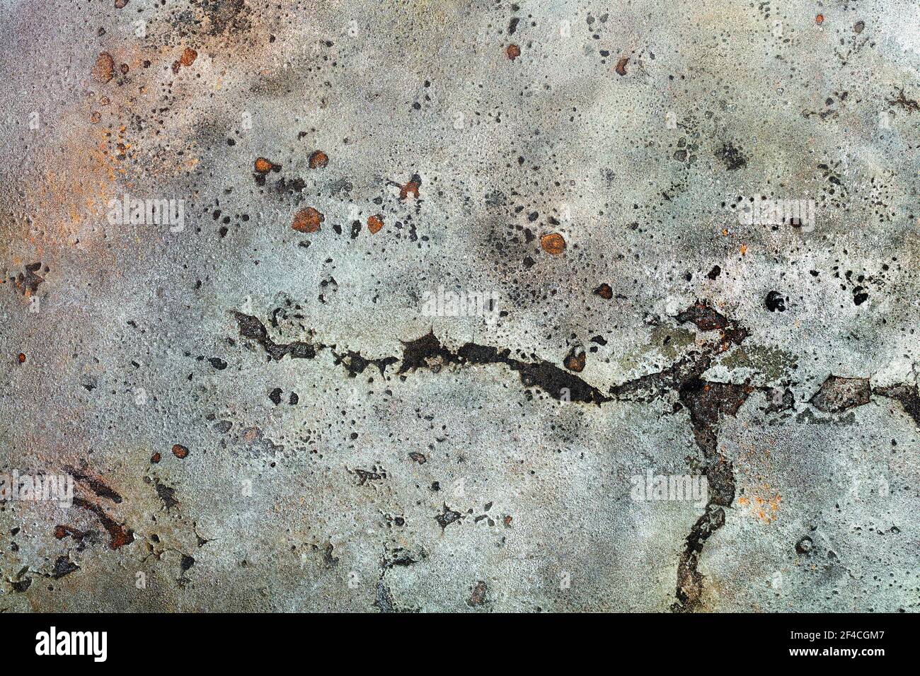 Metal texture covered with old weathered swollen paint with rust stains ...