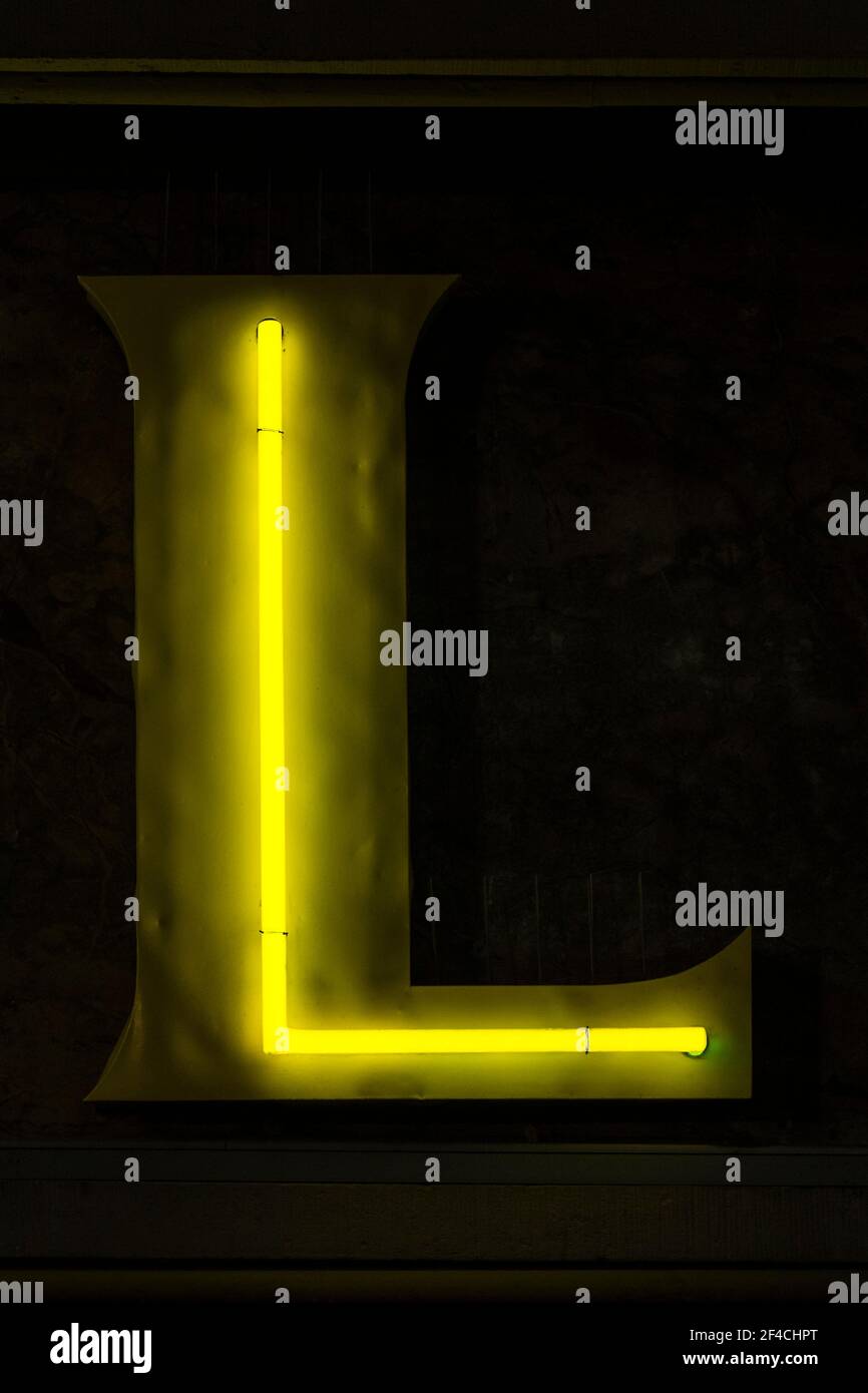 Glowing yellow neon letter L Stock Photo - Alamy