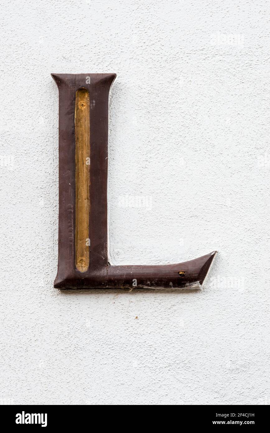 Brown wooden letter L with golden decorative lines Stock Photo - Alamy