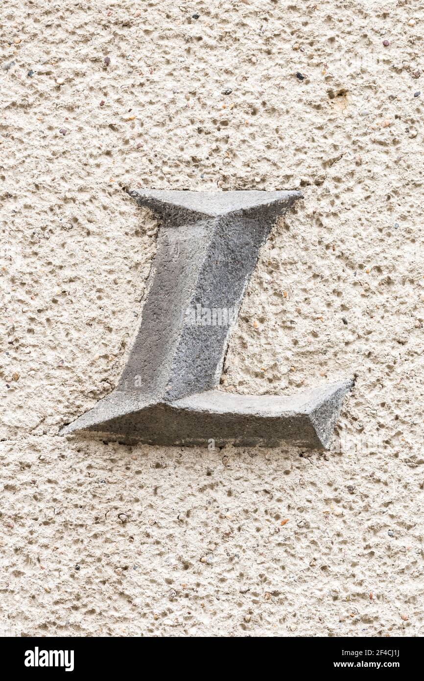 Capital letter L on roughly plastered wall Stock Photo - Alamy