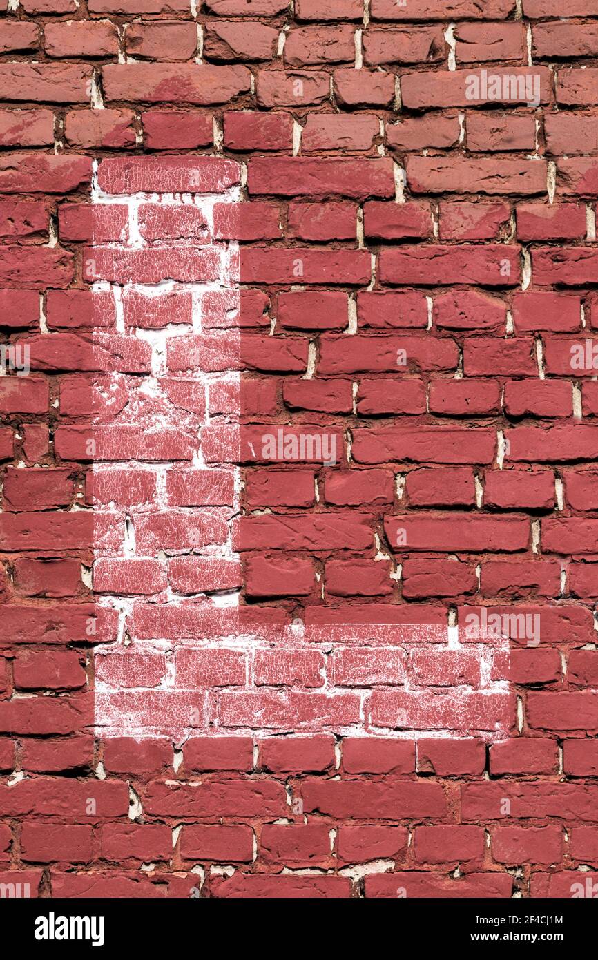 The letter L painted white on a red brick wall Stock Photo - Alamy