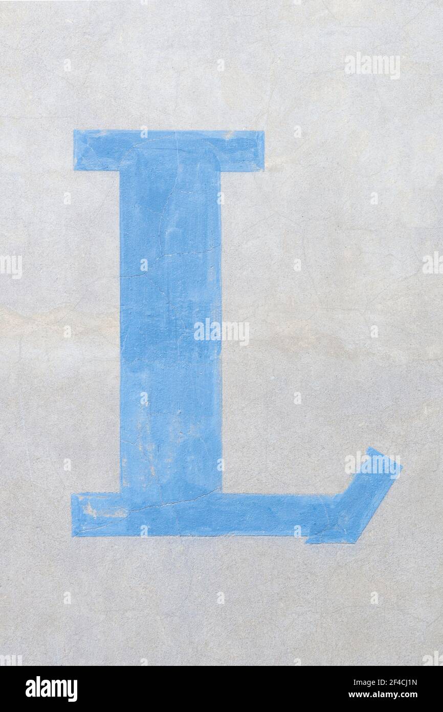 Light blue letter L in serif font on a light grey wall Stock Photo - Alamy