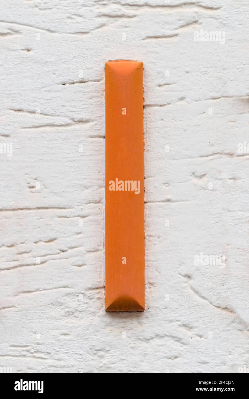 Orange letter l on a white house wall Stock Photo - Alamy