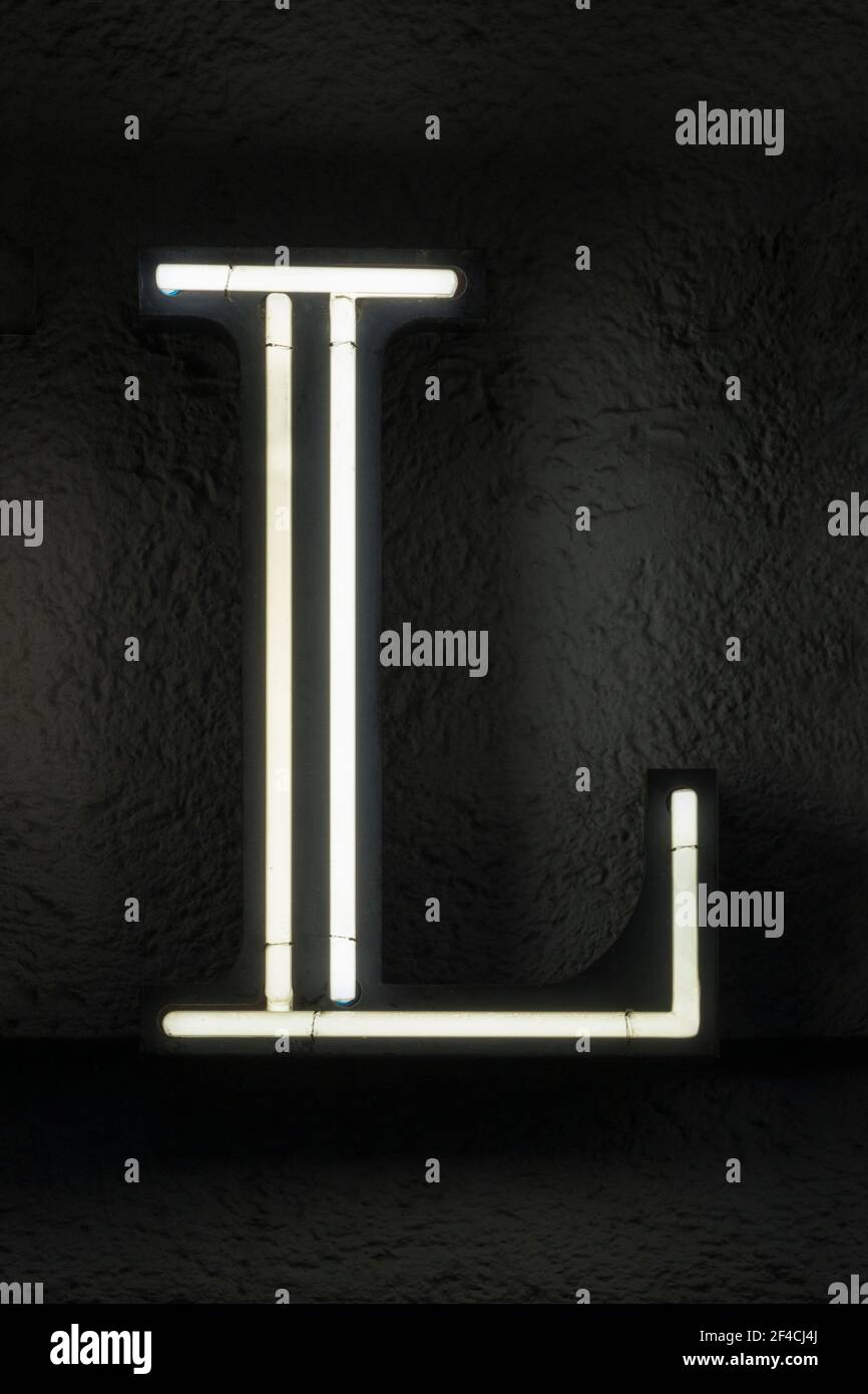 White neon letter L glowing in the dark Stock Photo - Alamy