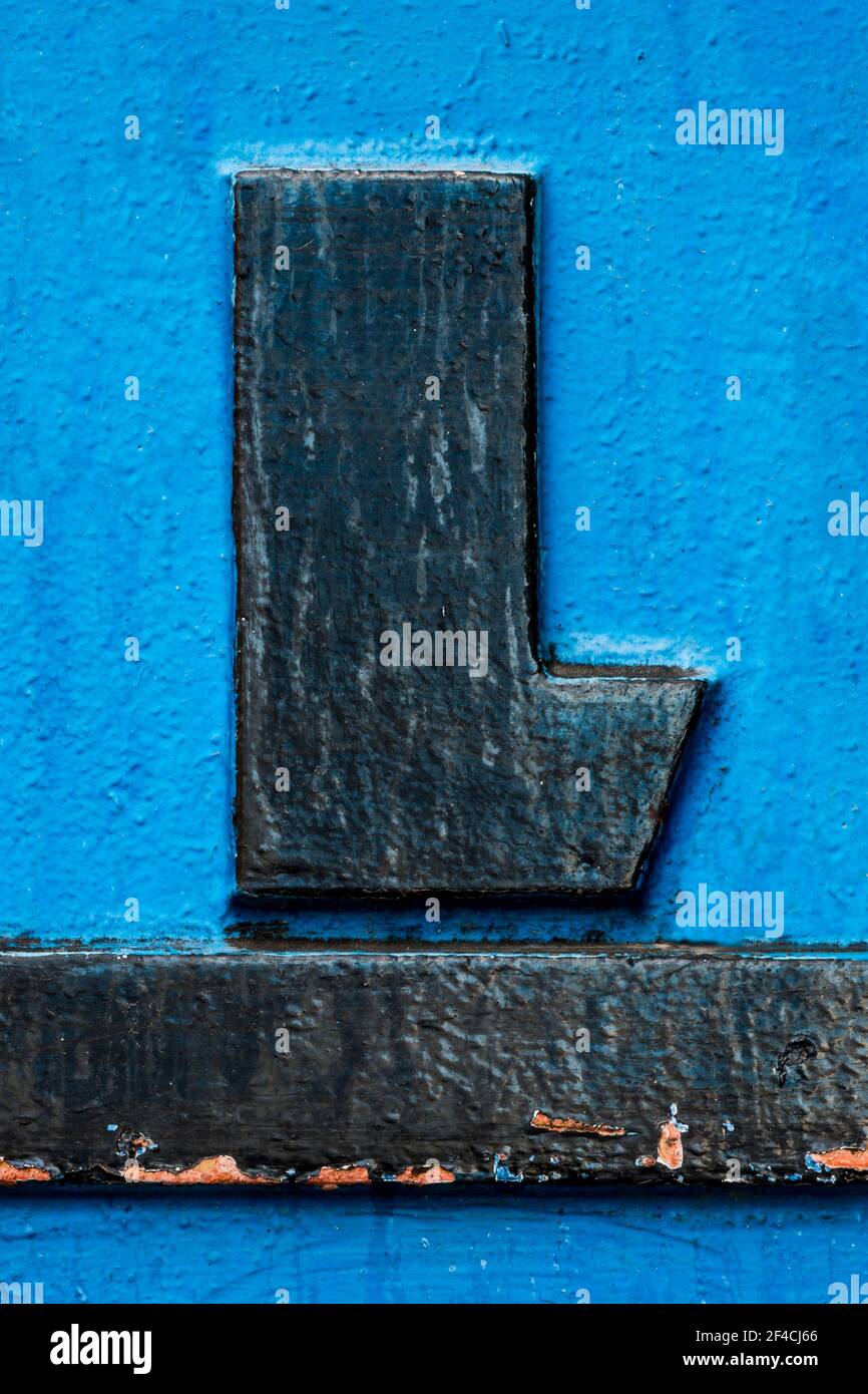 Black metal letter L with black underline on blue background Stock ...