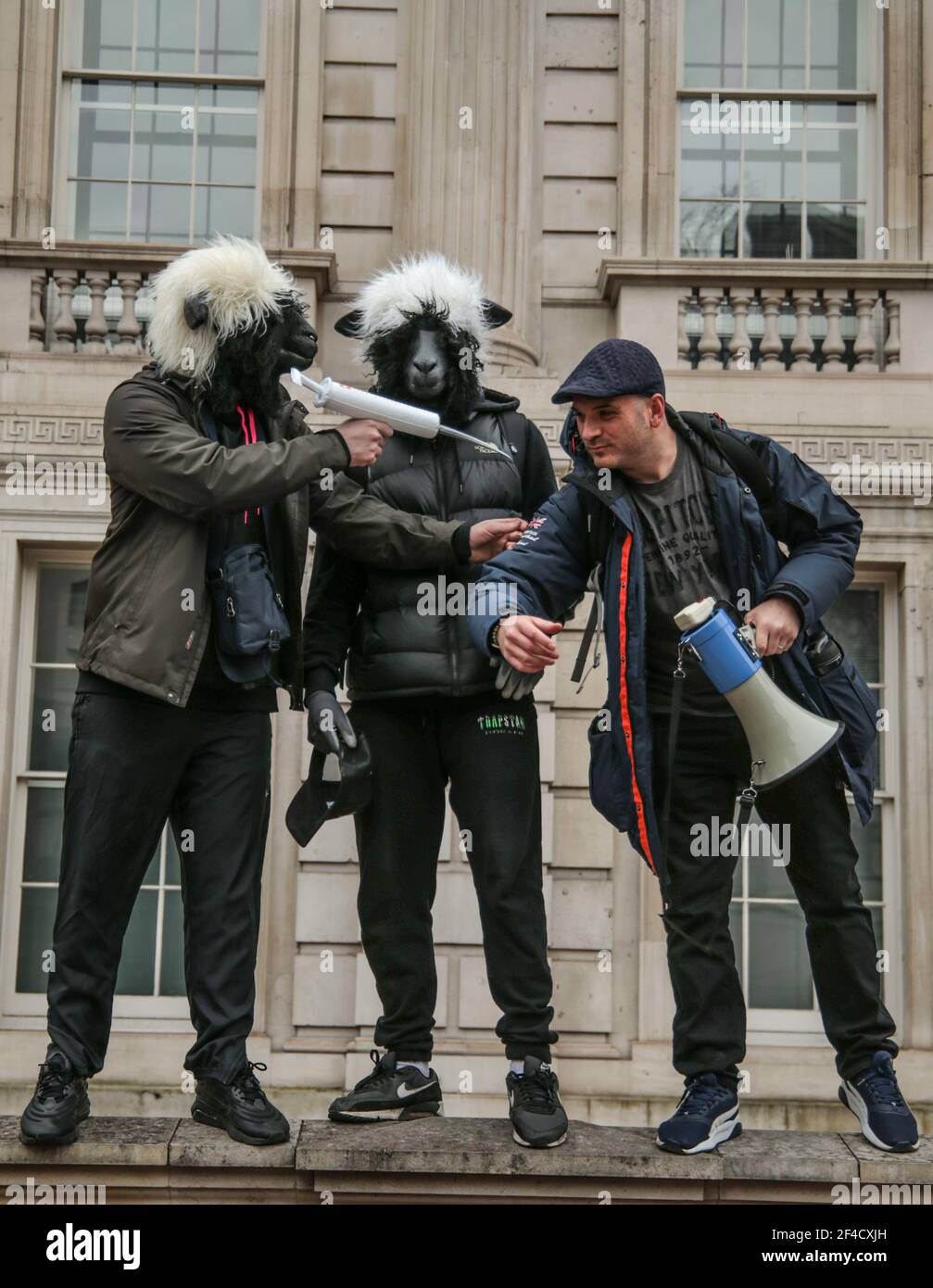 Two men dressed as sheep with a giant inyection hi-res stock ...