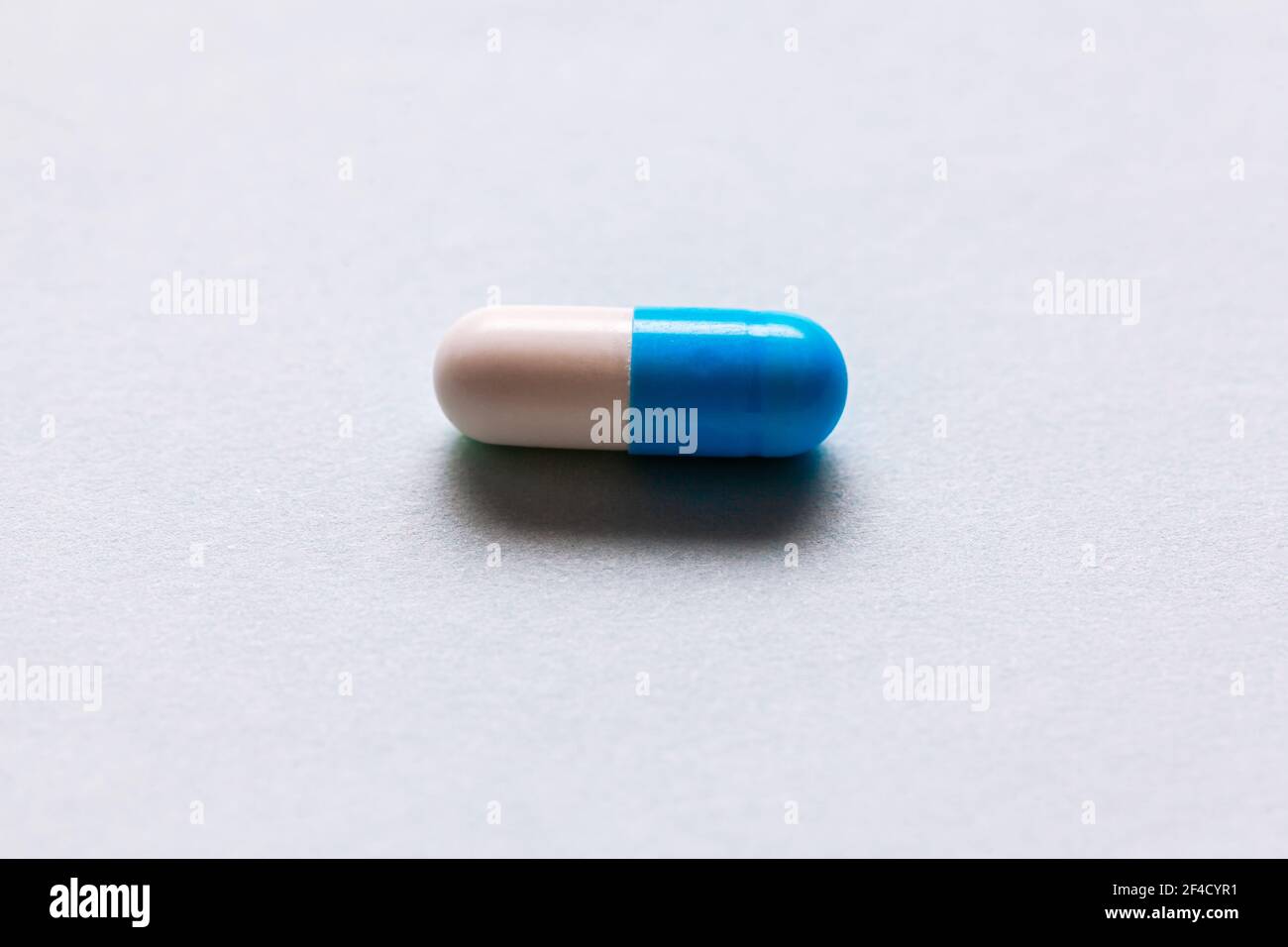 Blue and White Capsule pill at white background . Plastic Pill Medicine ...