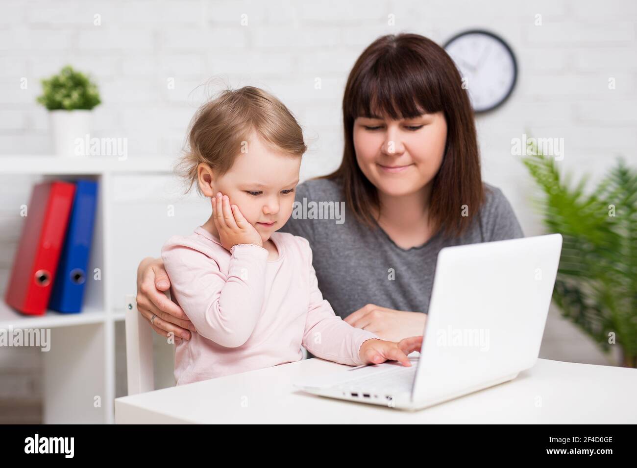 childhood, education and technology concept - mother or teacher ...