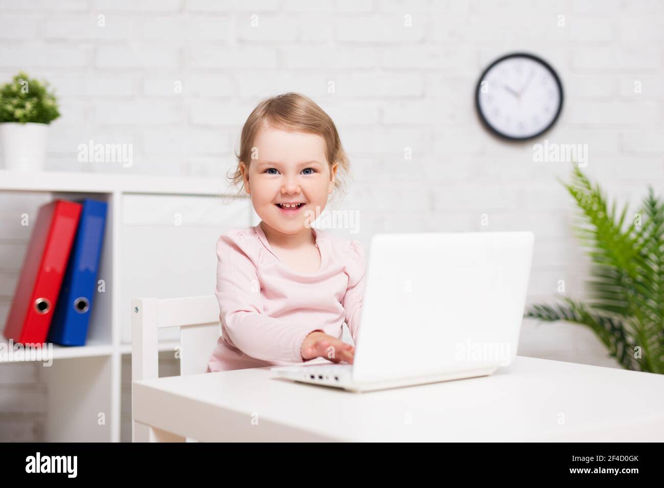 childhood, education and technology concept - happy cute little girl ...