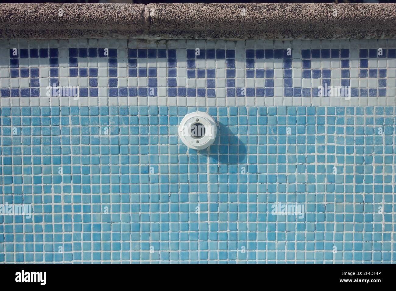 Pool vacuum hole in the empty stoneware swimming pool with blue and ...