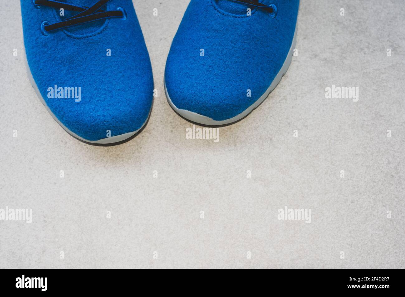 A top view of blue felt shoes on a white ground Stock Photo - Alamy