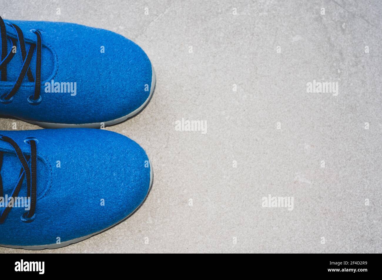 A top view of blue felt shoes on a white ground Stock Photo - Alamy