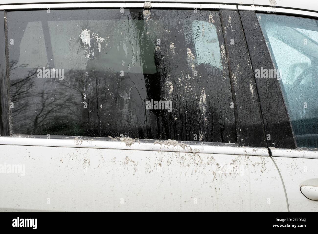 Smudges of cement or dirt on a car body, concept of a property damage ...