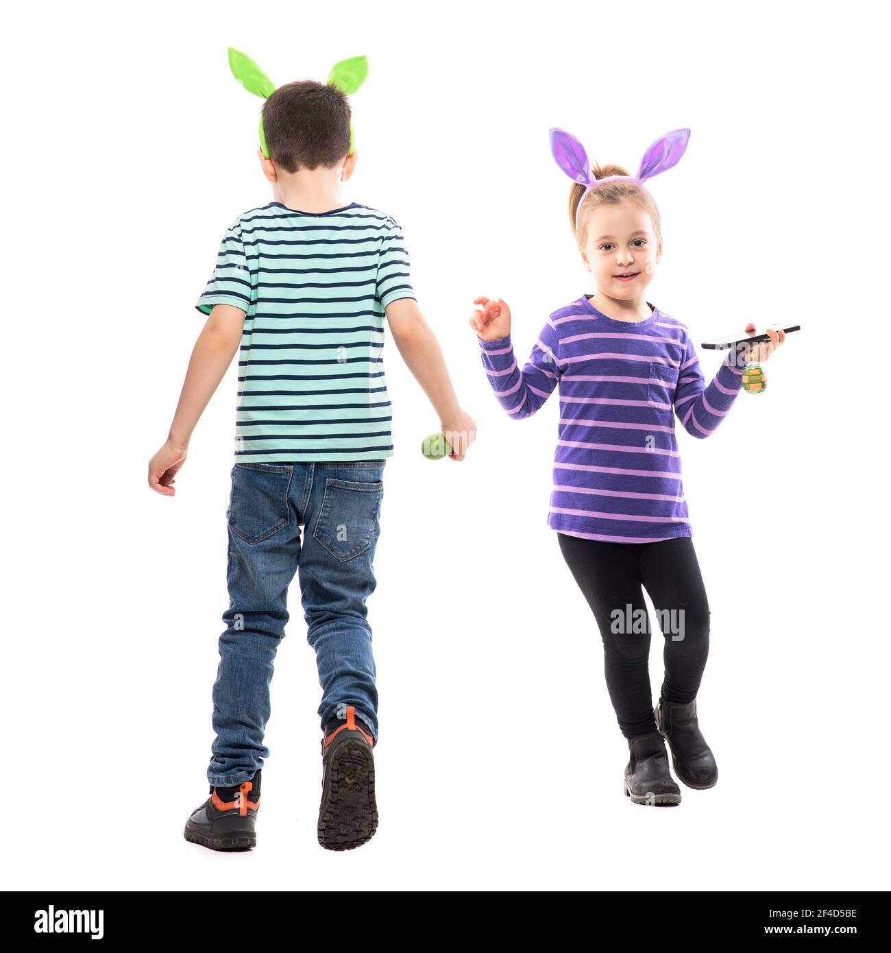 Back view of young boy and front view of girl with phone dancing with ...