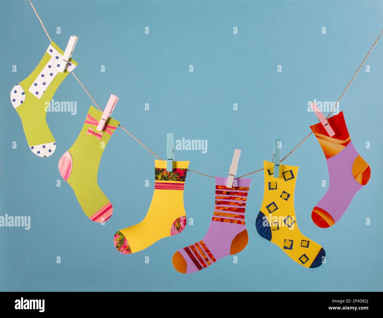 World Down Syndrome Day concept. Different socks in clothesline on blue ...