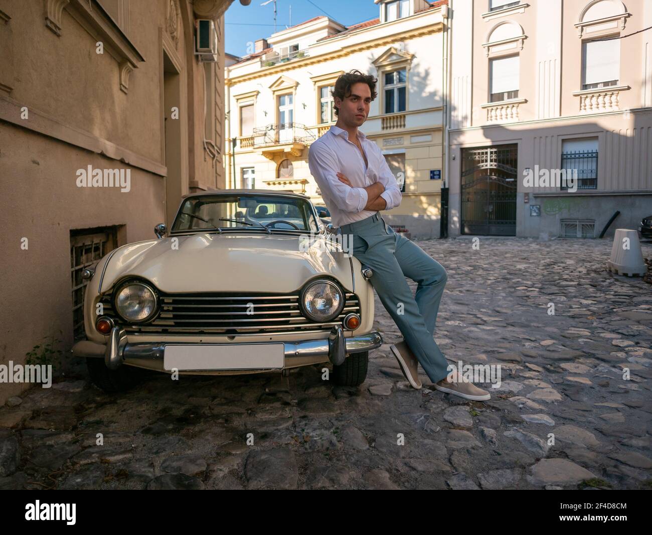 Portrait of young handsome guy. Bored and annoyed man on the street ...