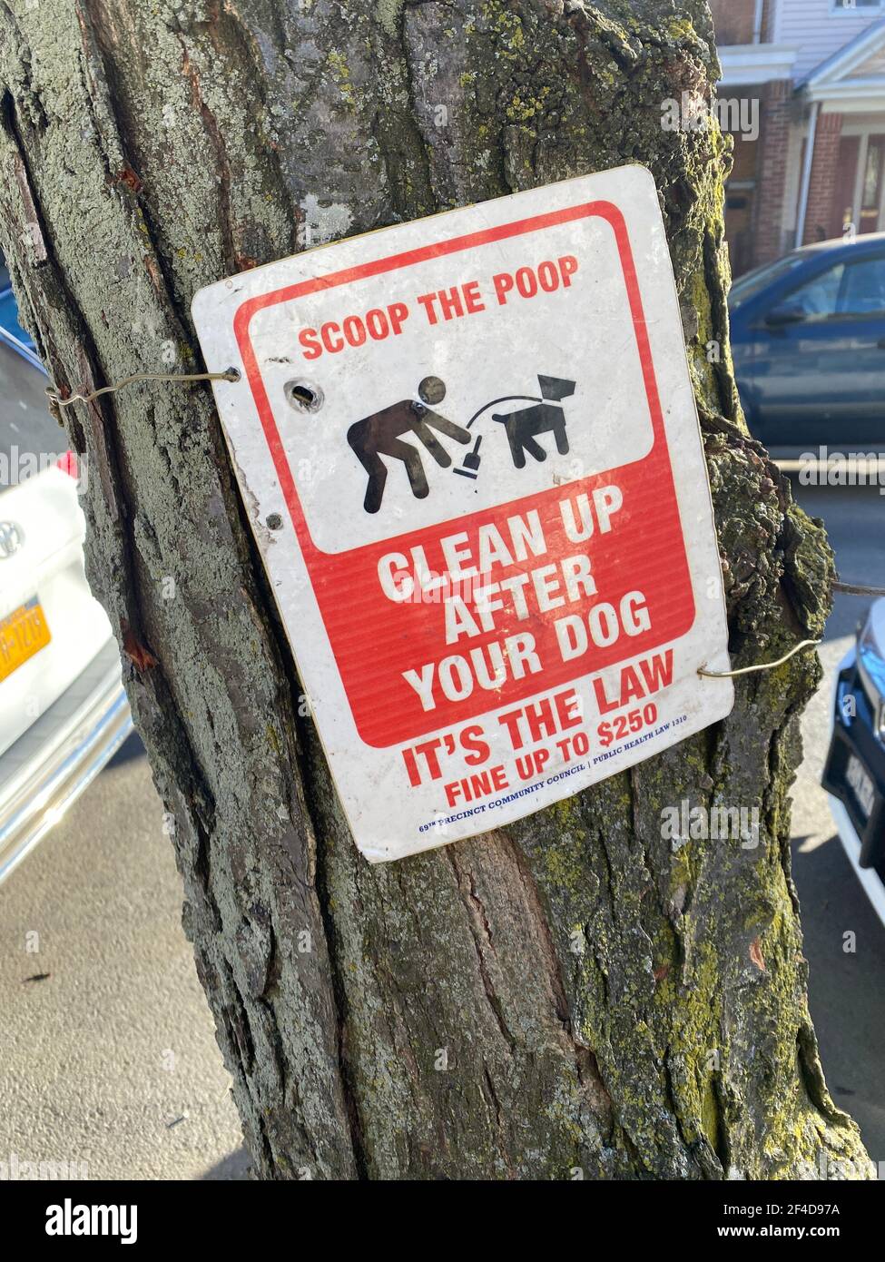 Sign posted on a tree in a residential Brooklyn neighborhood reminding ...
