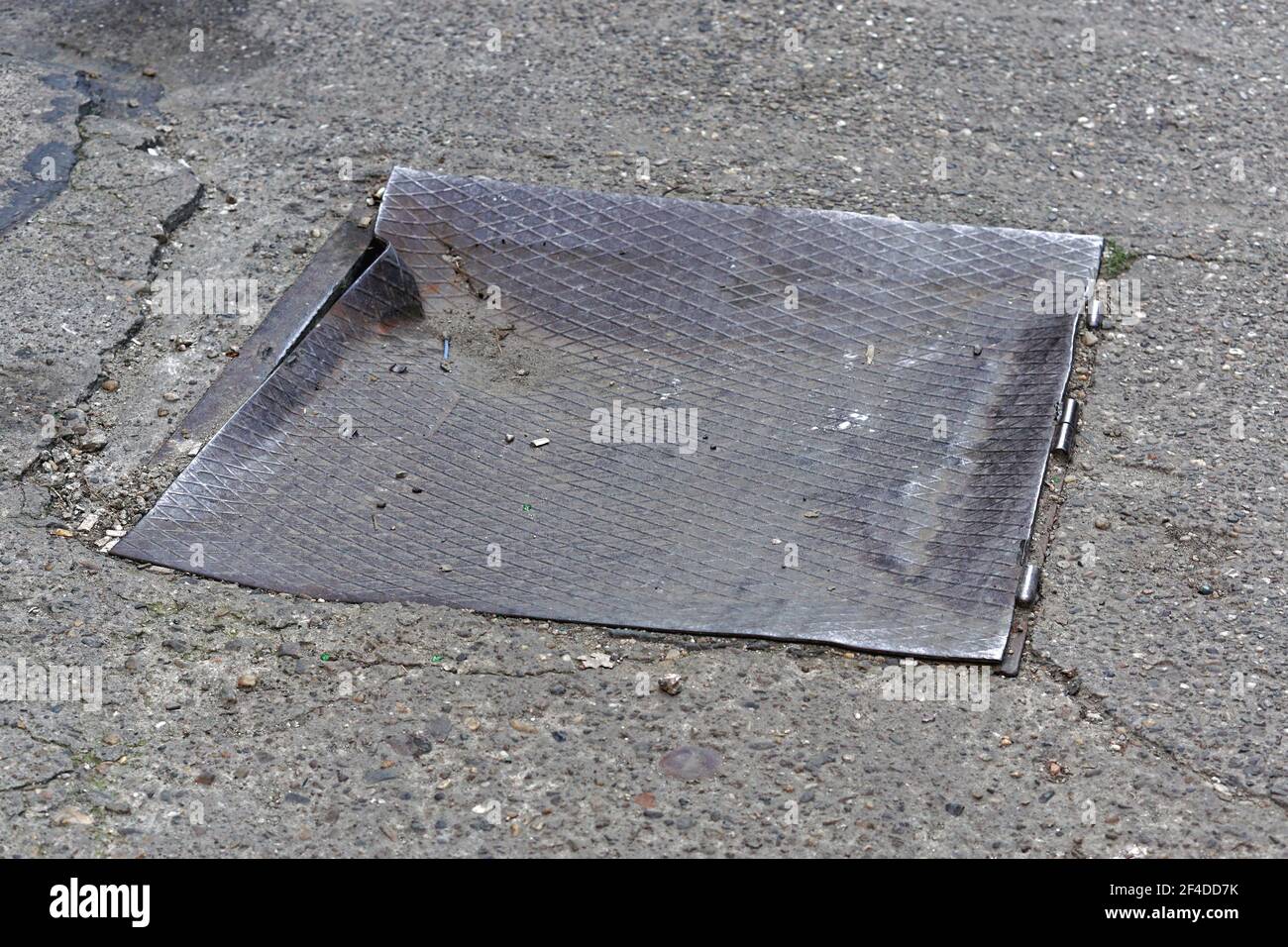Broken manhole shaft lid danger damage Stock Photo - Alamy
