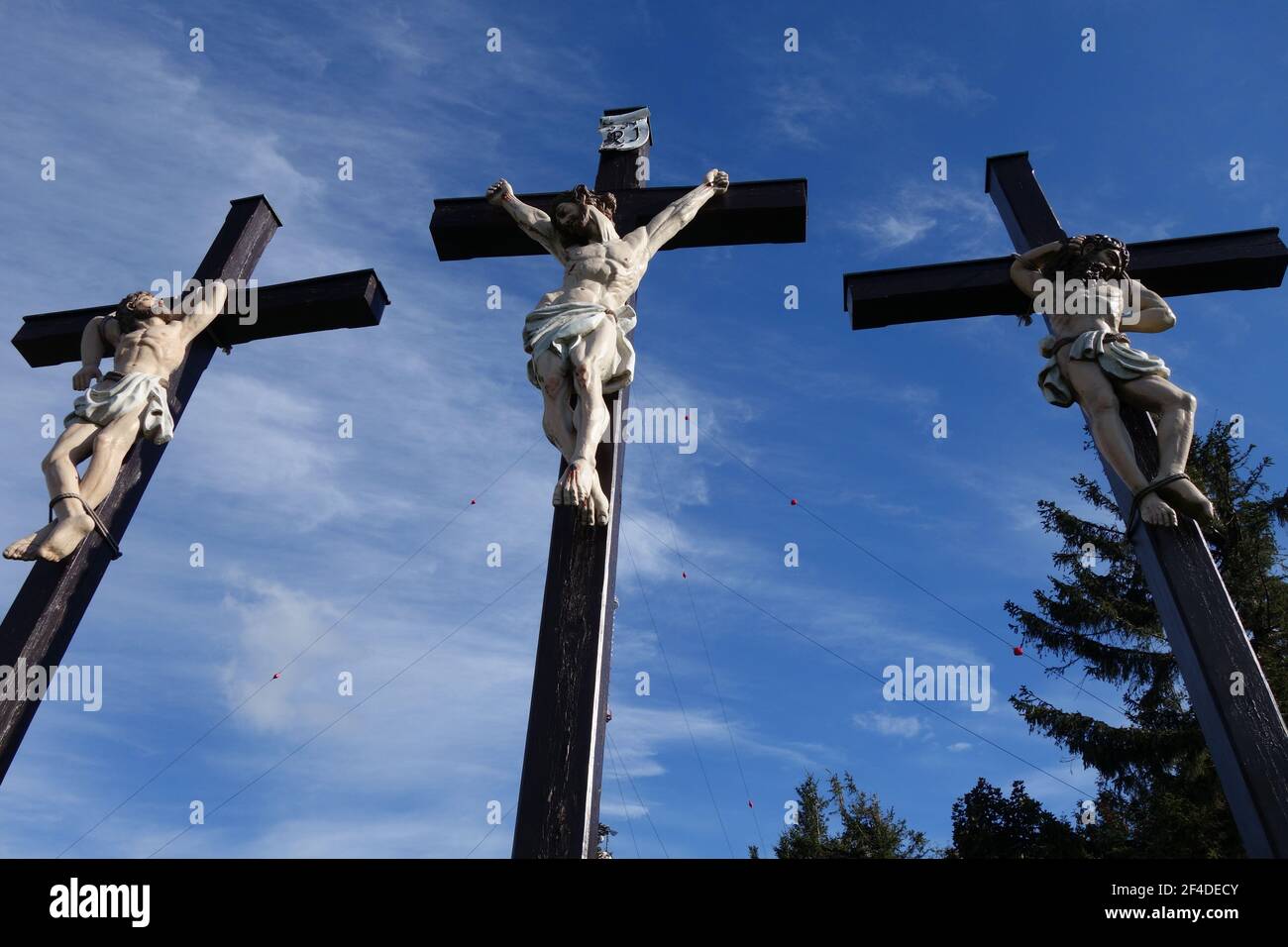 A low angle shot of statues of people crucified on crosses Stock Photo ...