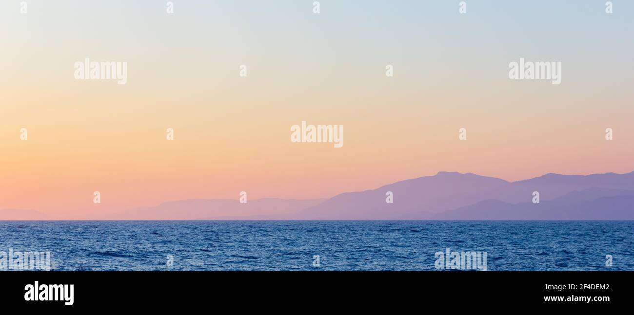 Seascape with fog and mountains. Seascape at sunset. View from the sea ...