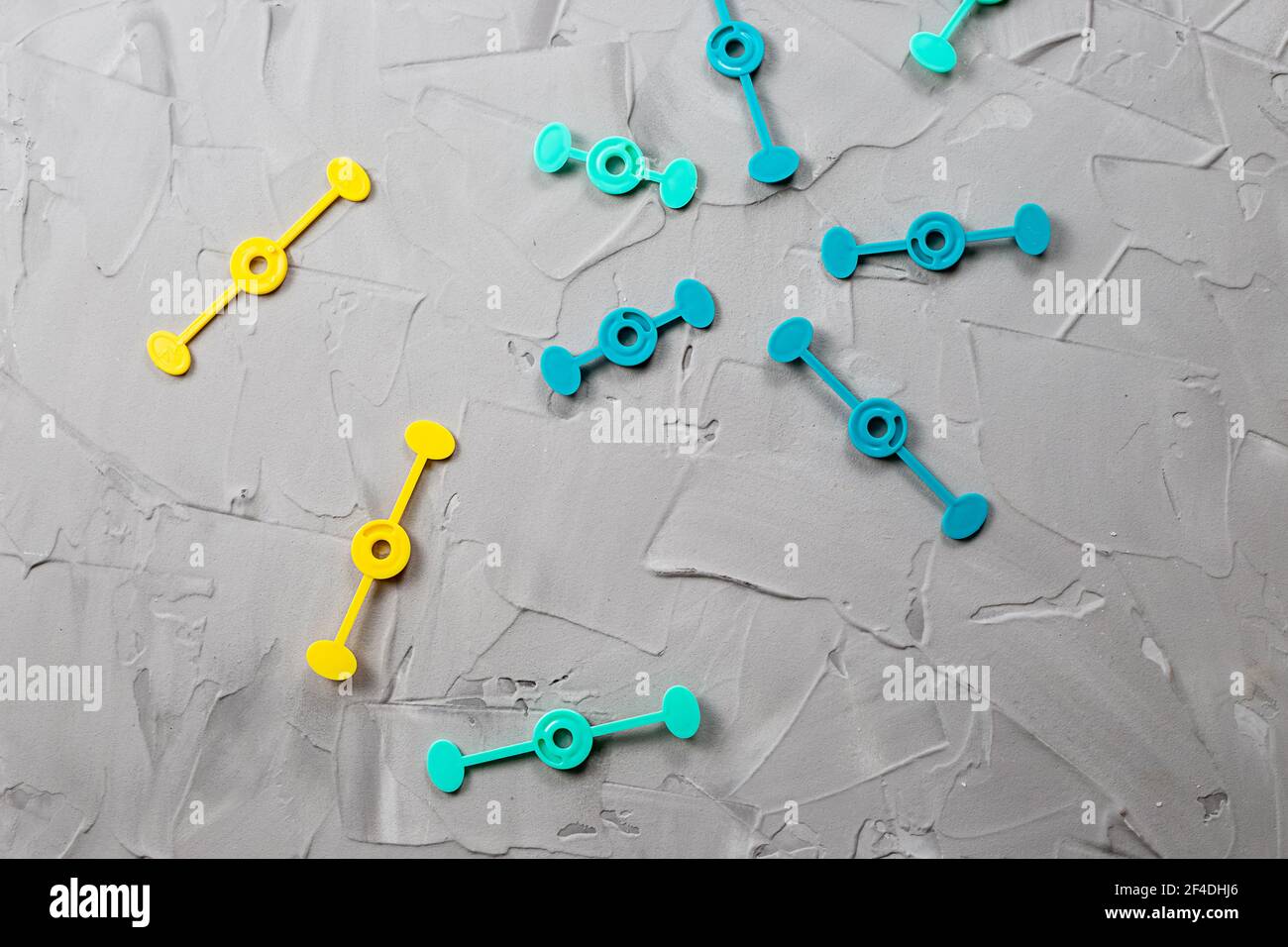 Abstract background with plastic colored parts on gray concrete can ...