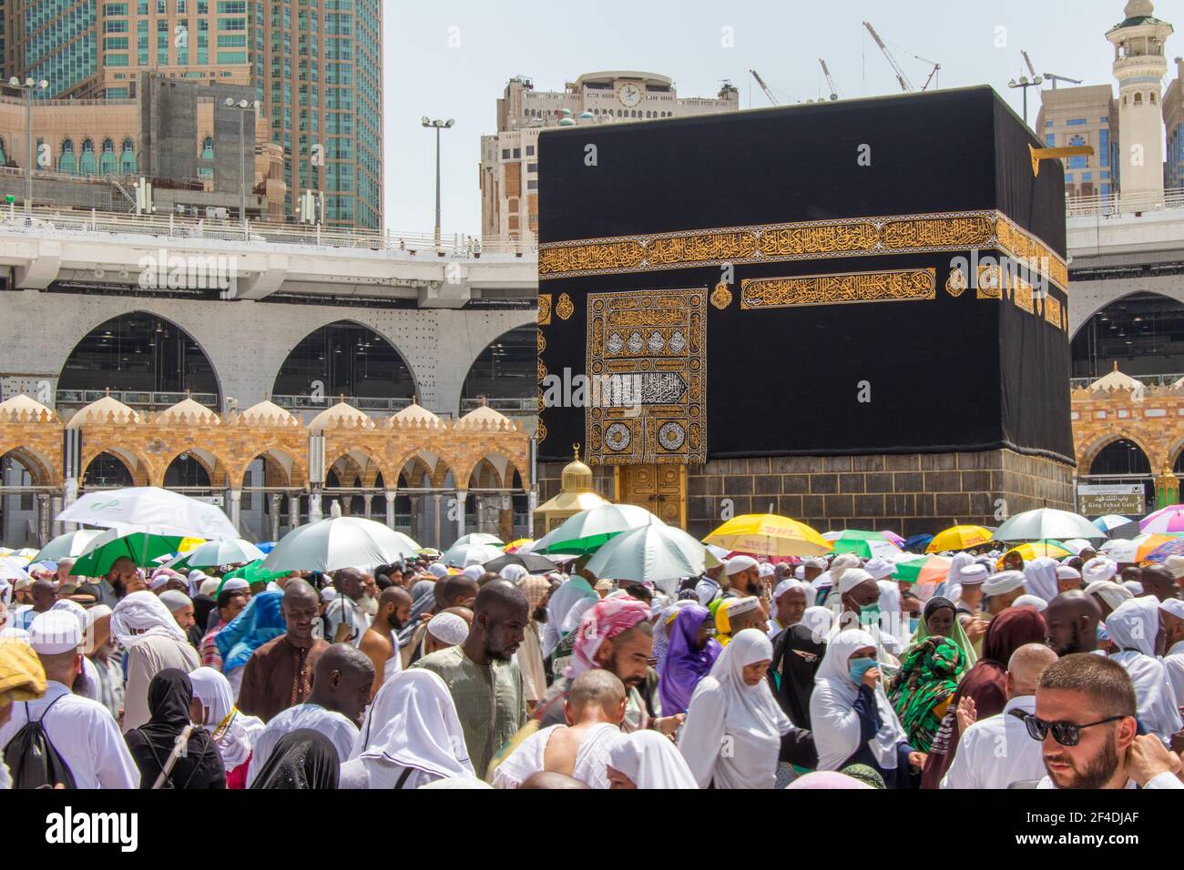 Crowd of people walking around Kaaba. Muslim pilgrims in the courtyard ...