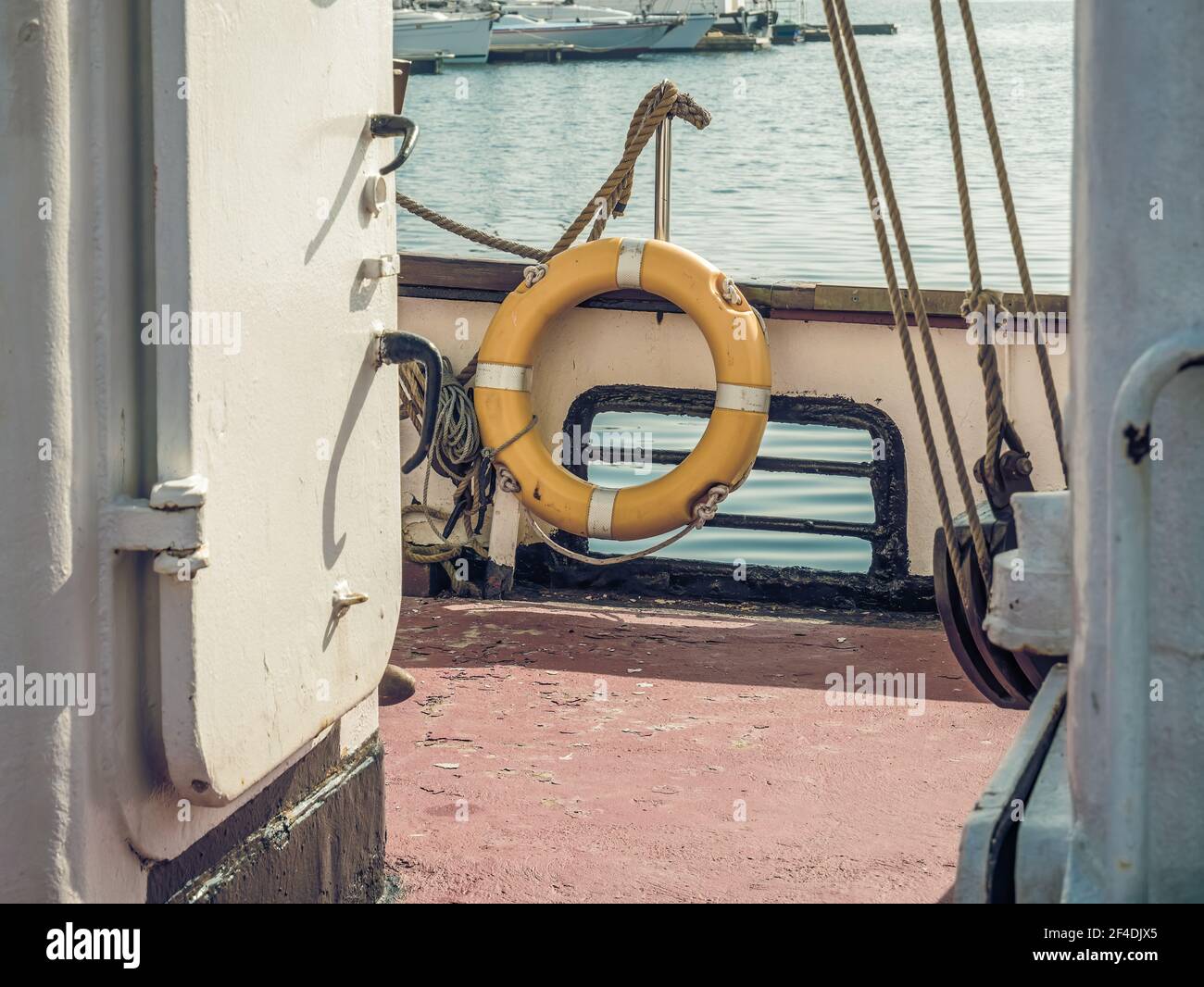 A yellow lifebelt, lifebuoy, water wheely also known as Kisbee ring on ...