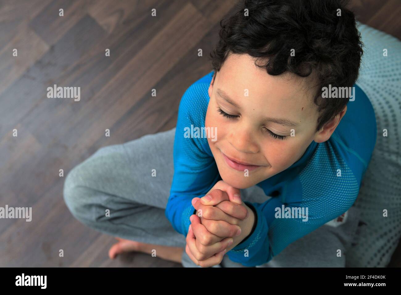 boy praying to God with hands together on white background stock photo ...